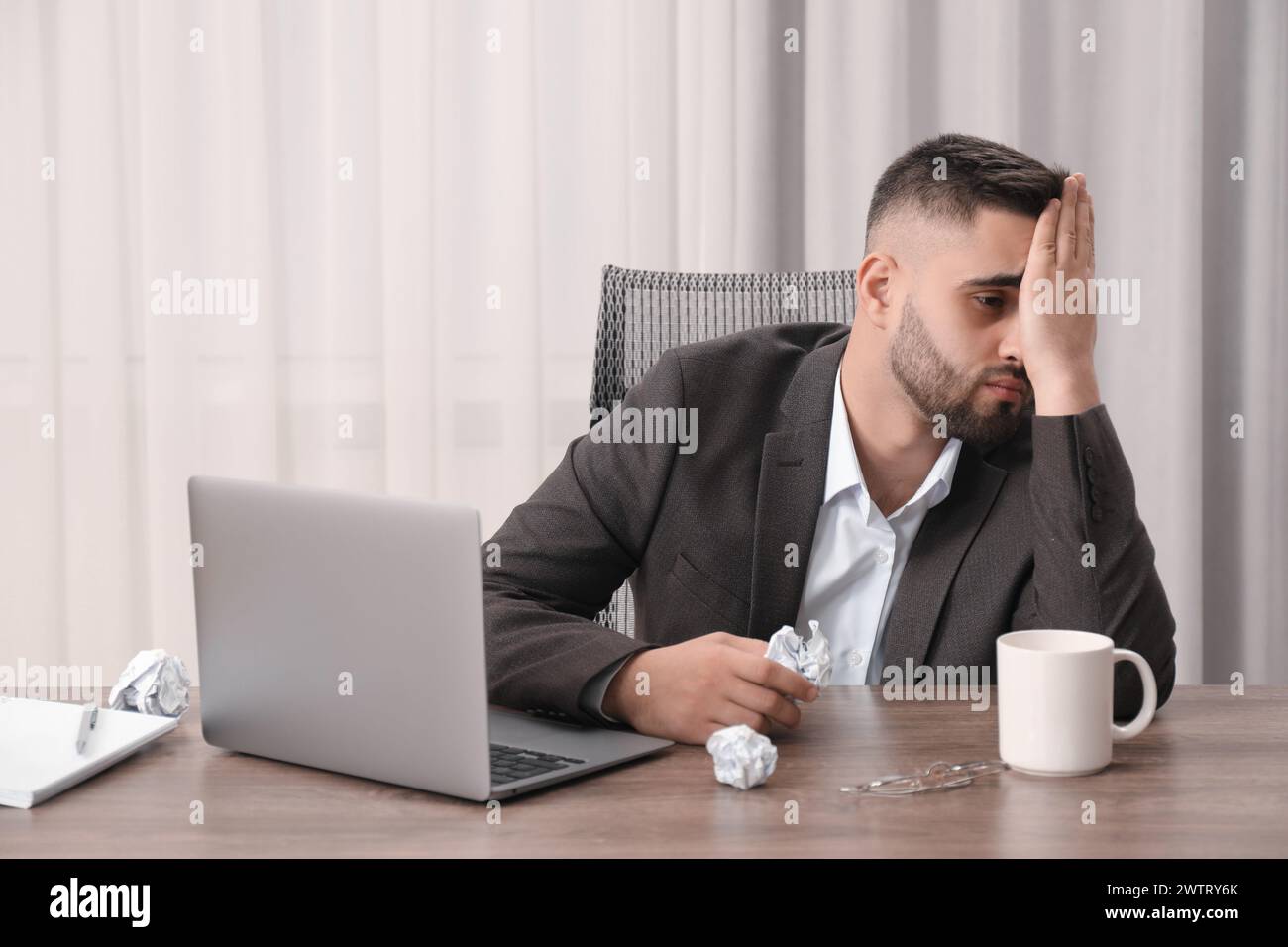 Sad businessman sitting table hi-res stock photography and images - Alamy