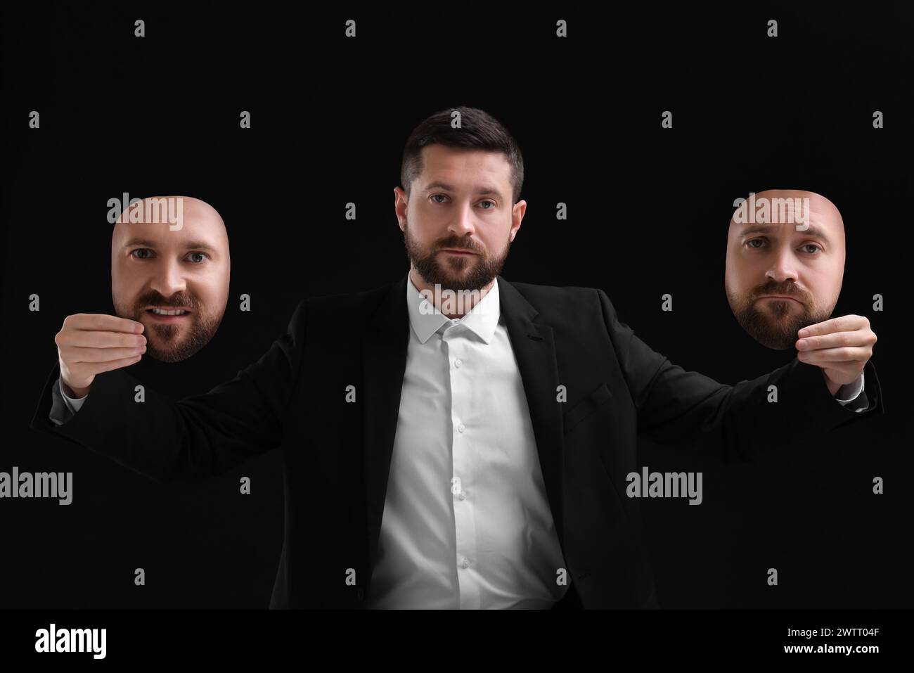 Man holding masks with his face showing different emotions on black ...