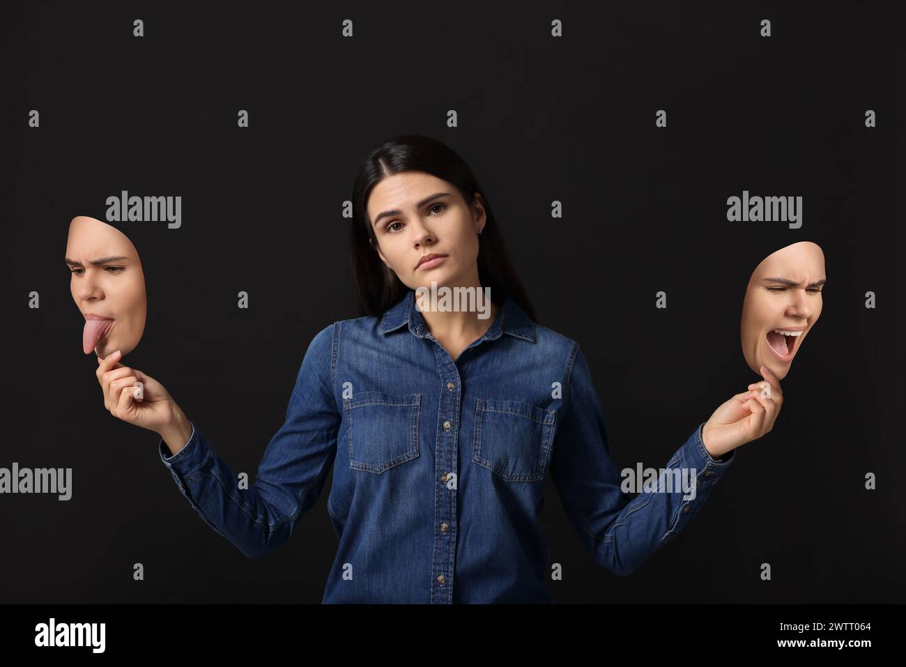 Woman holding masks with her face showing different emotions on black ...