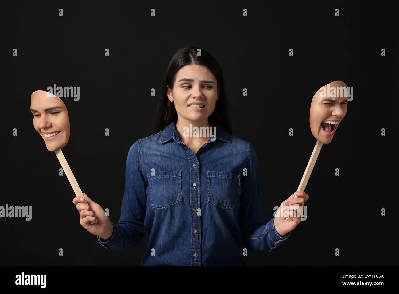 Woman holding masks with her face showing different emotions on black ...