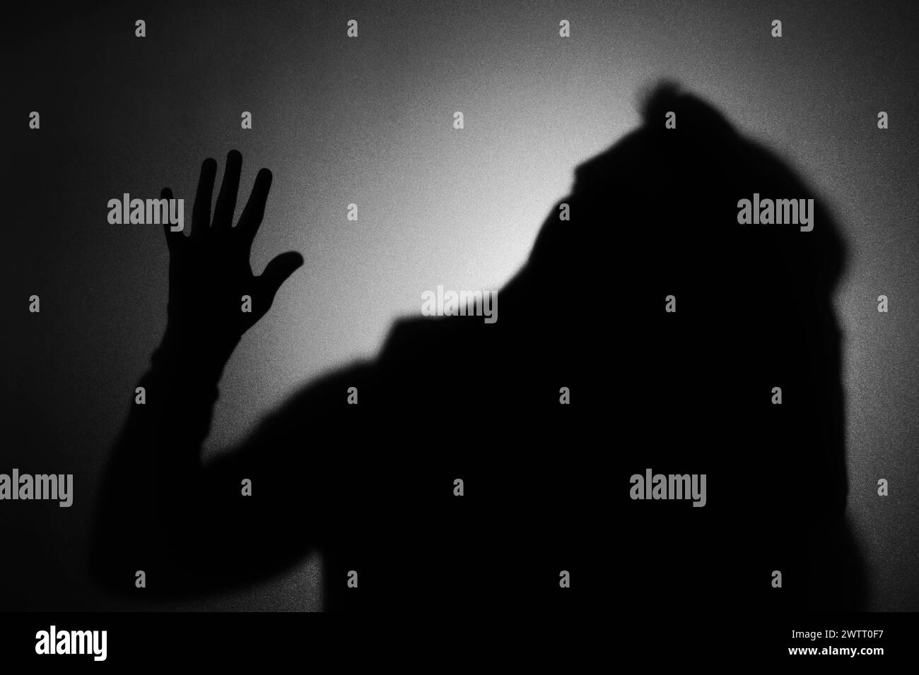 Silhouette of ghost behind glass against dark background Stock Photo ...