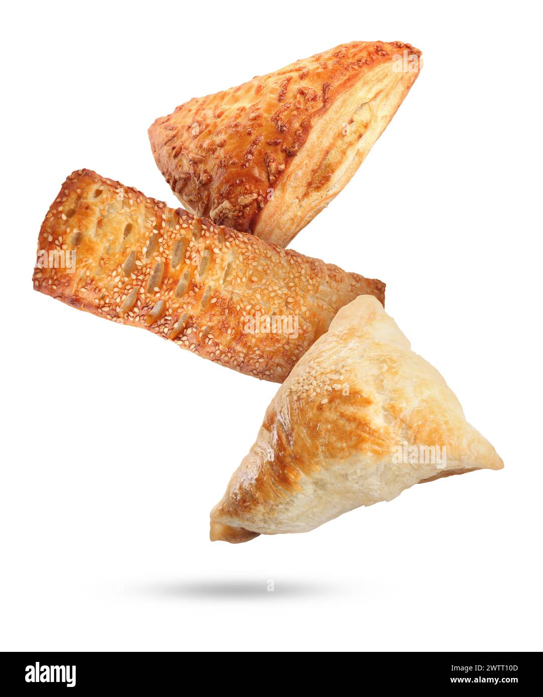 Different tasty puff pastries falling on white background Stock Photo ...