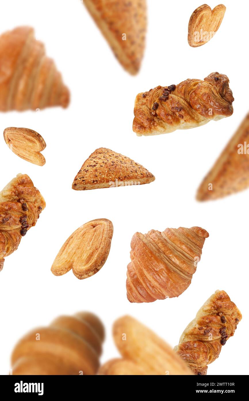 Different tasty puff pastries falling on white background Stock Photo ...