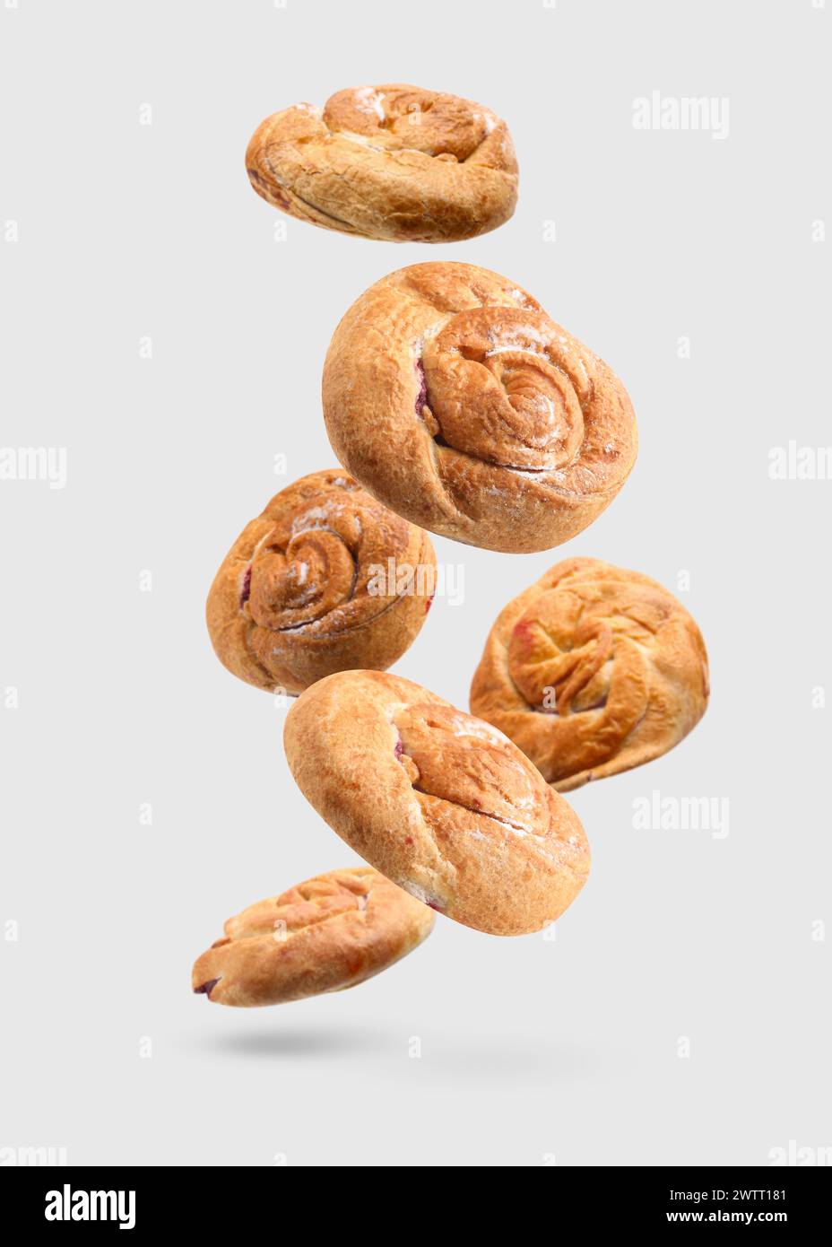 Sweet buns. Delicious rolls with jam falling on light grey background ...