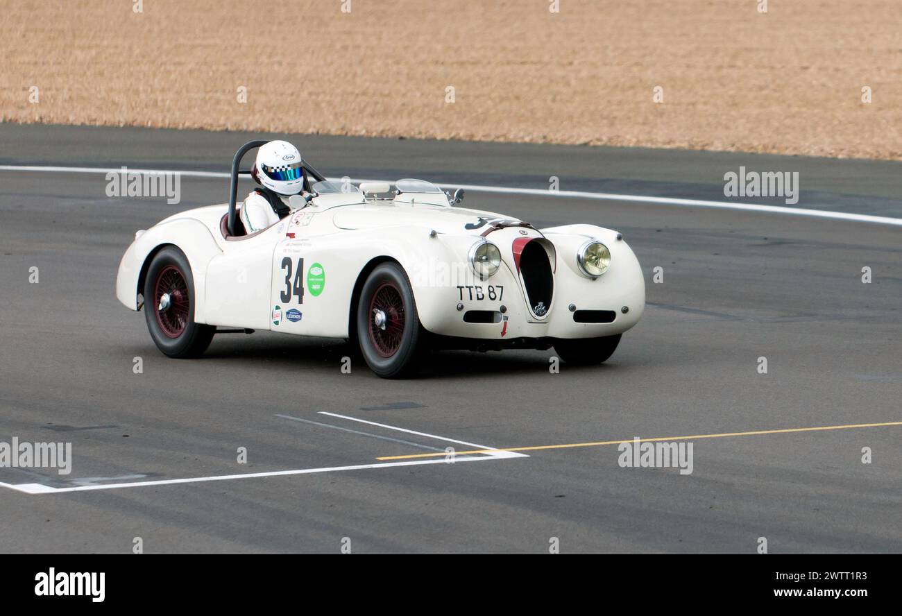 Christopher Scholey driving his White, 1954, Jaguar XK120, in the ...