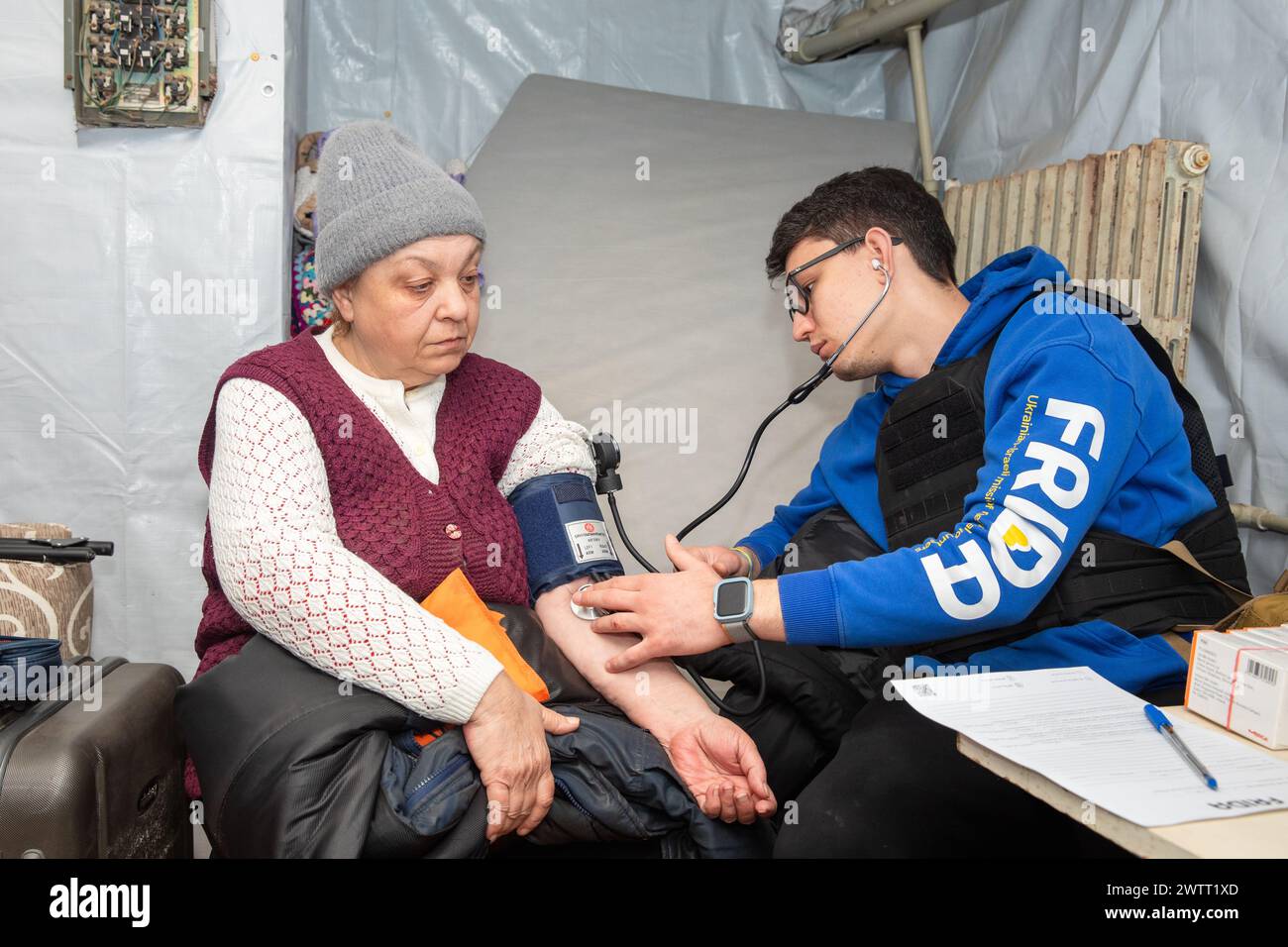 A doctor from the Frida Ukraine Volunteer Mission is seen checking the ...