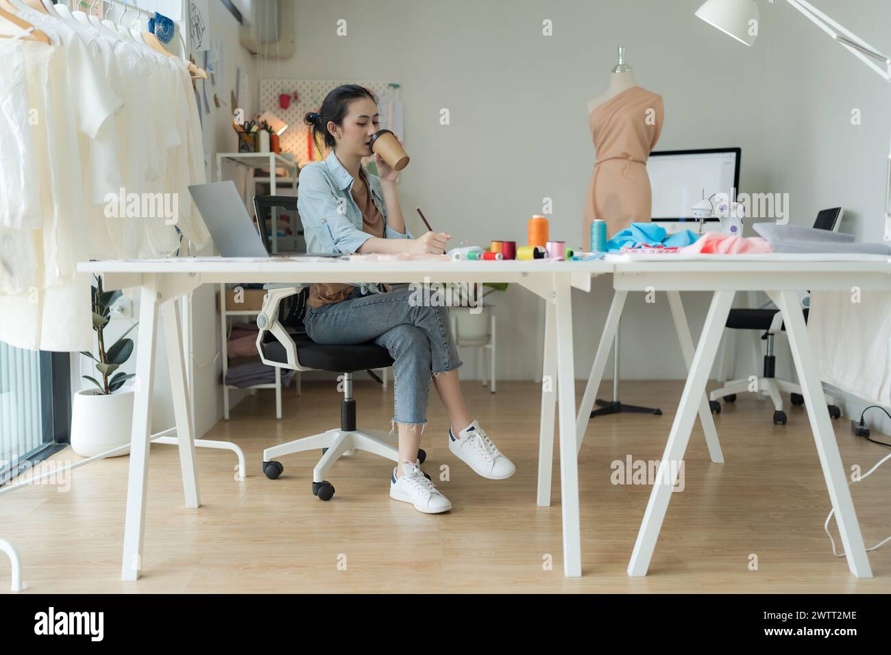 Female entrepreneurs are making new clothing collections from her design with a modern Stock ...