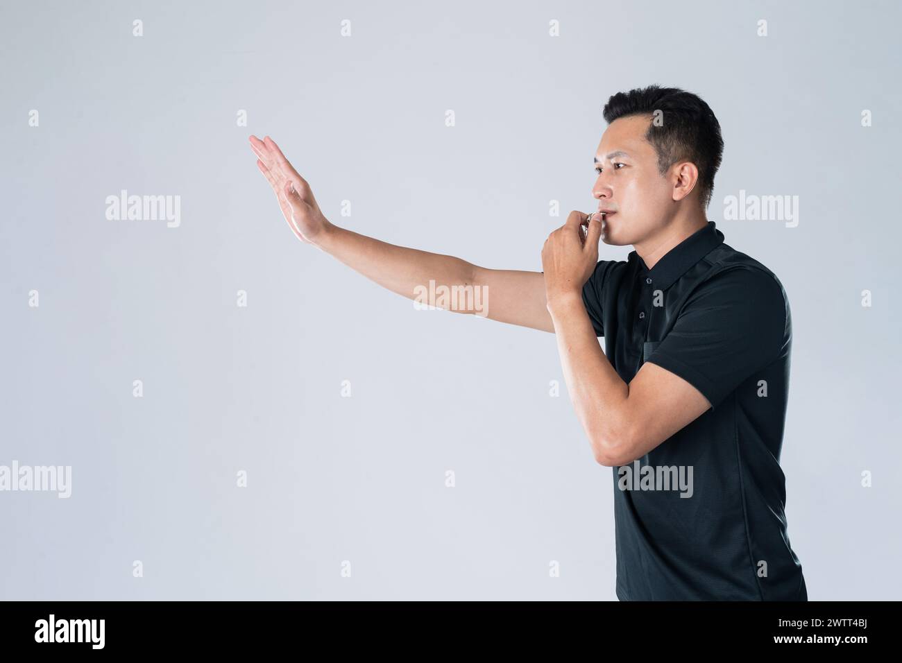 Football referee holding whistle and pointing with isolated hand on ...