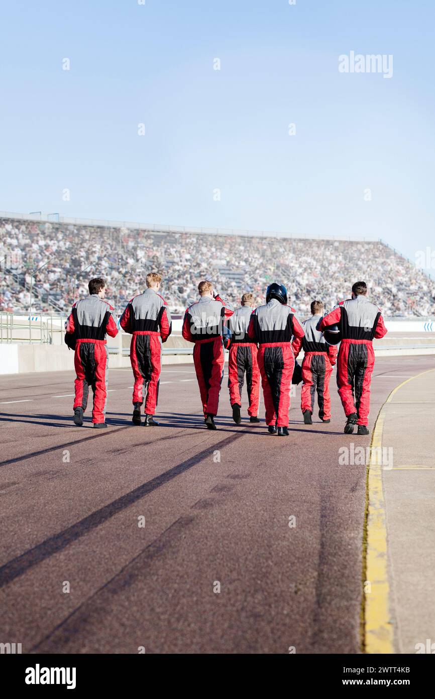Pit crew team walking confidently on the racetrack Stock Photo - Alamy