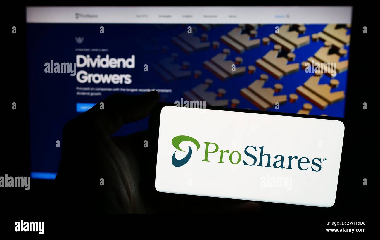 Person holding mobile phone with logo of American financial services ...