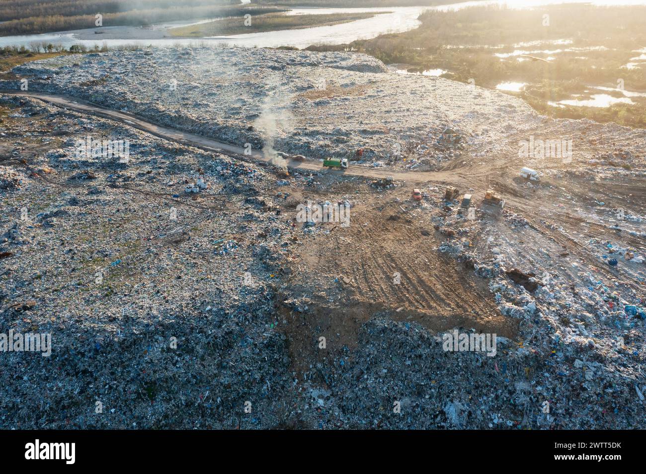 Aerial view of garbage pile in trash dump. Dump track drives trough ...