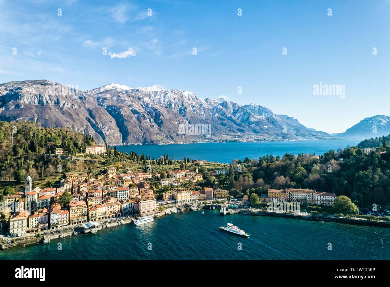 Aerial view of Bellagio village on Como lake with blue sky and the Alps ...