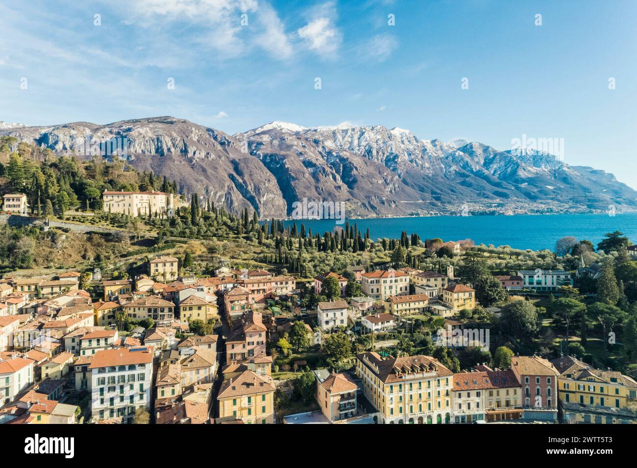 Aerial view of Bellagio village on Como lake with blue sky and the Alps ...