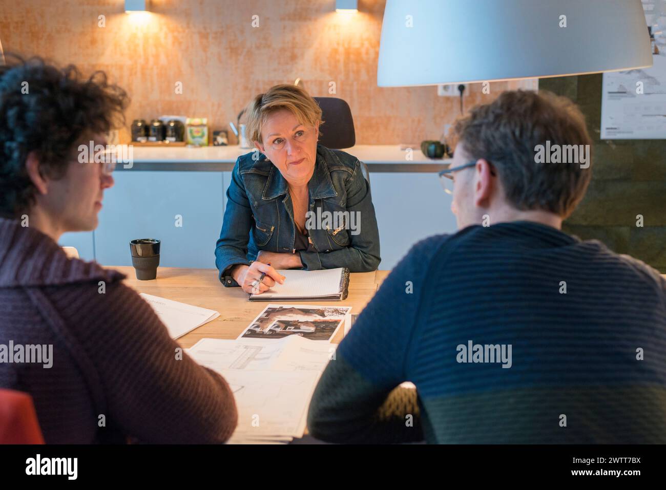 A focused meeting in progress with colleagues discussing over documents ... A focused meeting in progress with colleagues discussing over documents ...