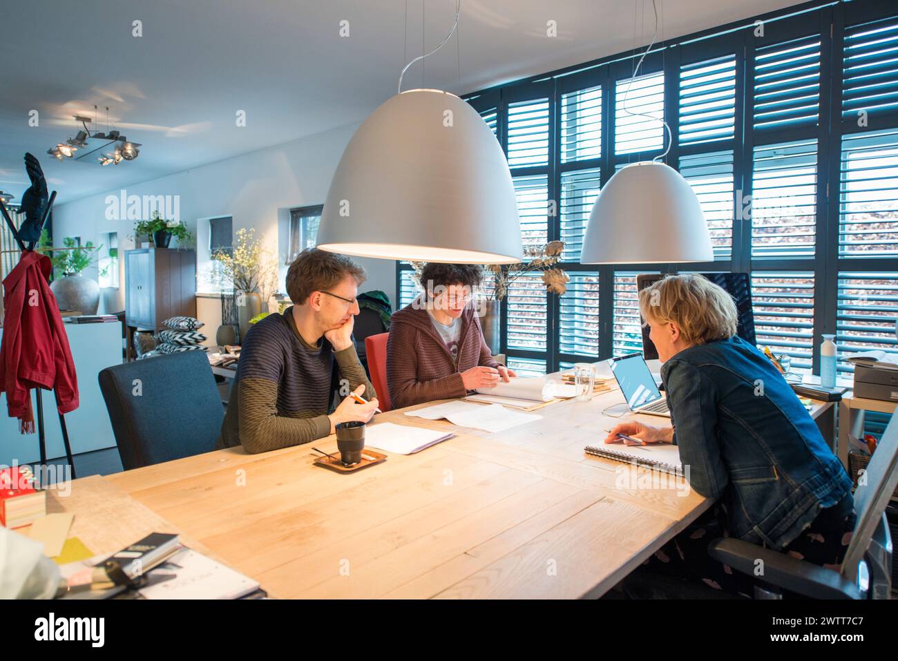 Colleagues collaborating on a project in a modern office setting Stock ...