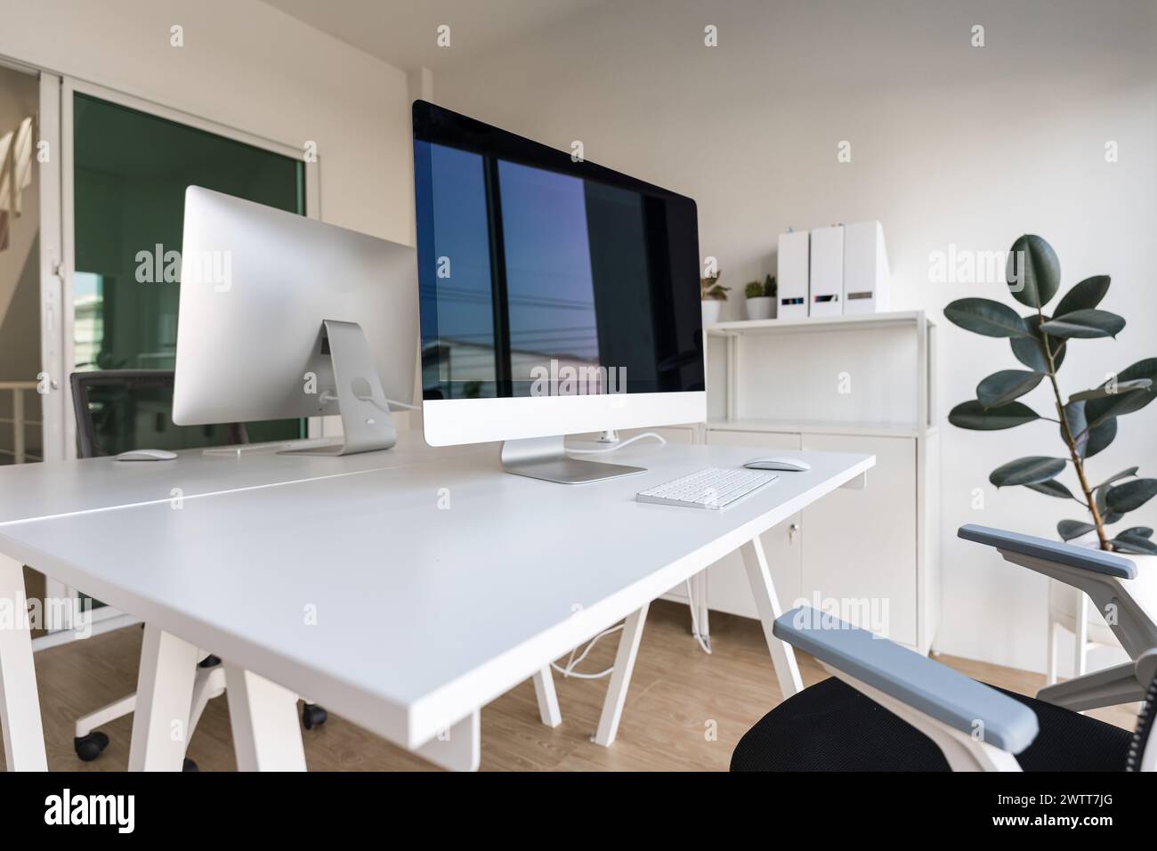 White table and chair with computer monitor and modern file cabinet in ...