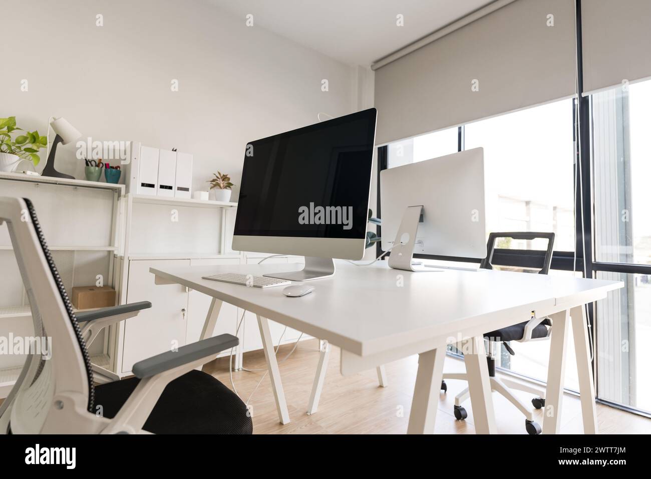 White table and chair with computer monitor and modern file cabinet in ...