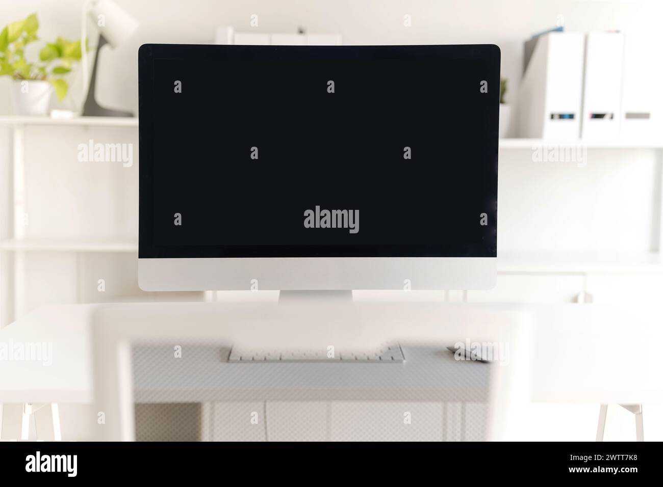 White table and chair with computer monitor and modern file cabinet in ...