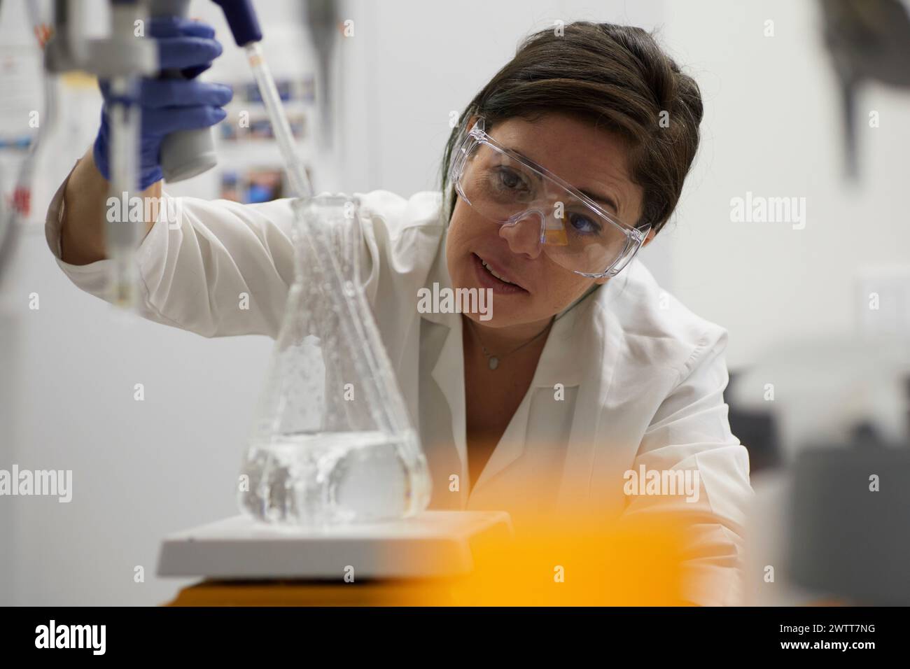 Chemist holding up beaker hi-res stock photography and images - Alamy