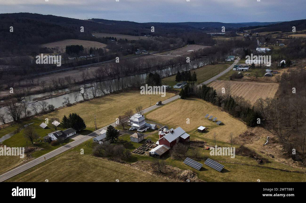 The Tioughnioga River runs by the Itaska Valley Farm, foreground, owned ...