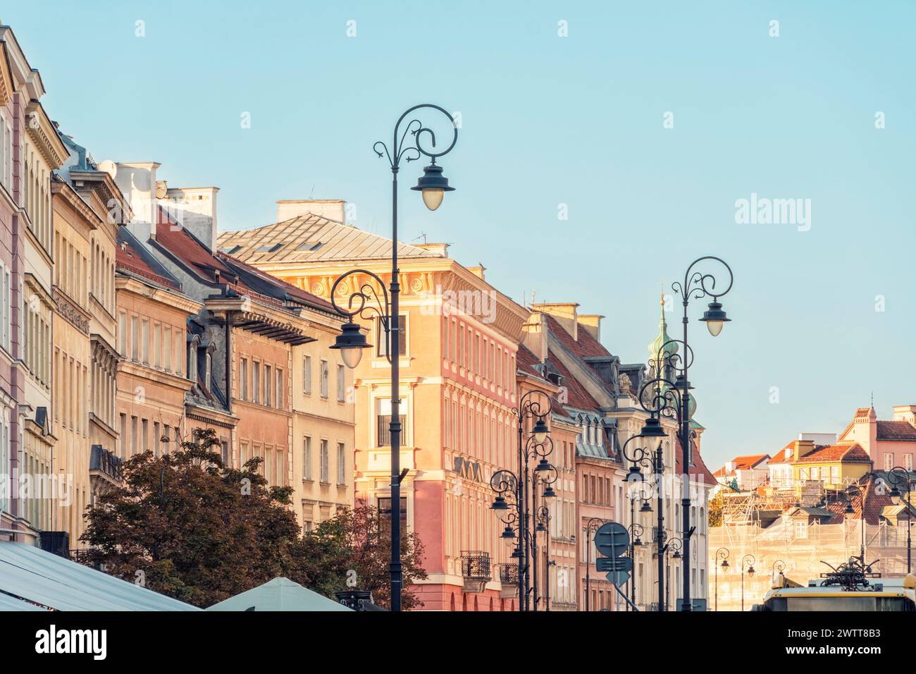 Warm sunlight bathing an elegant European street lined with vintage ...