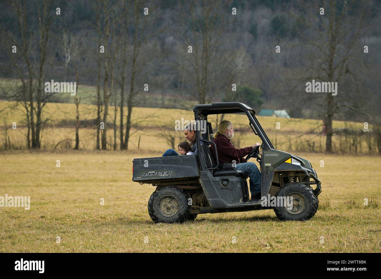 Harold Koster, right, drives his four-wheel vehicle around his 125-acre ...