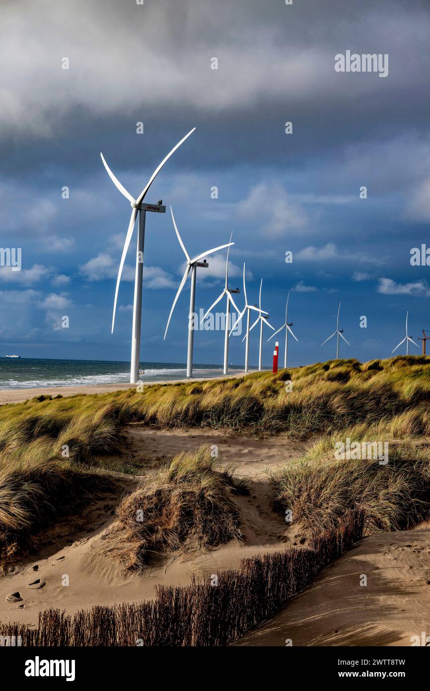 Coastal wind farm overlooking the sea with a dramatic sky backdrop ...
