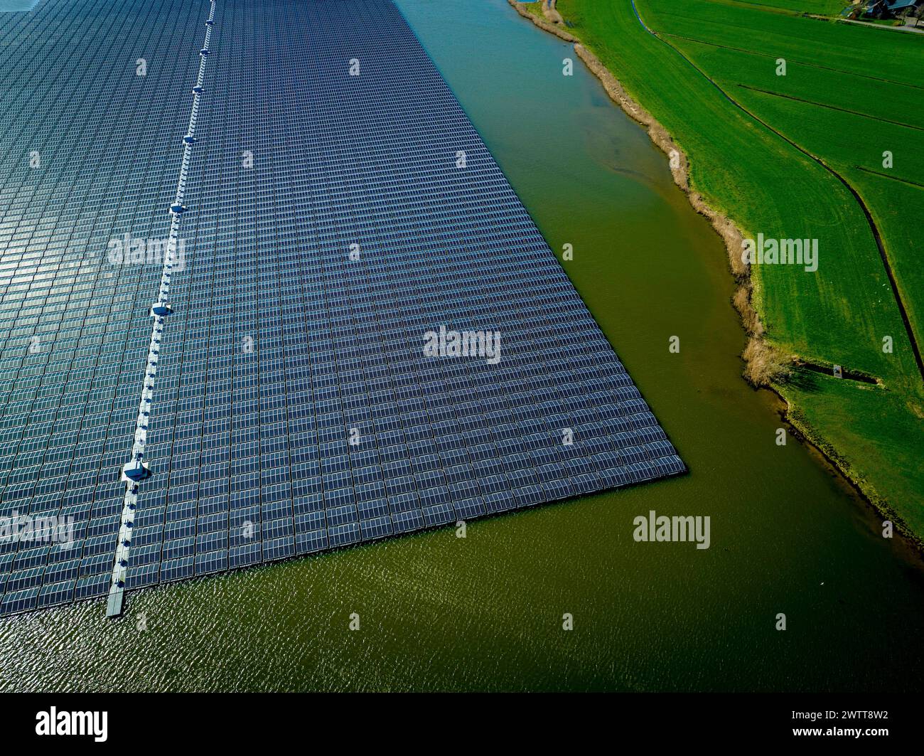 Aerial view of a solar farm next to a body of water Stock Photo - Alamy