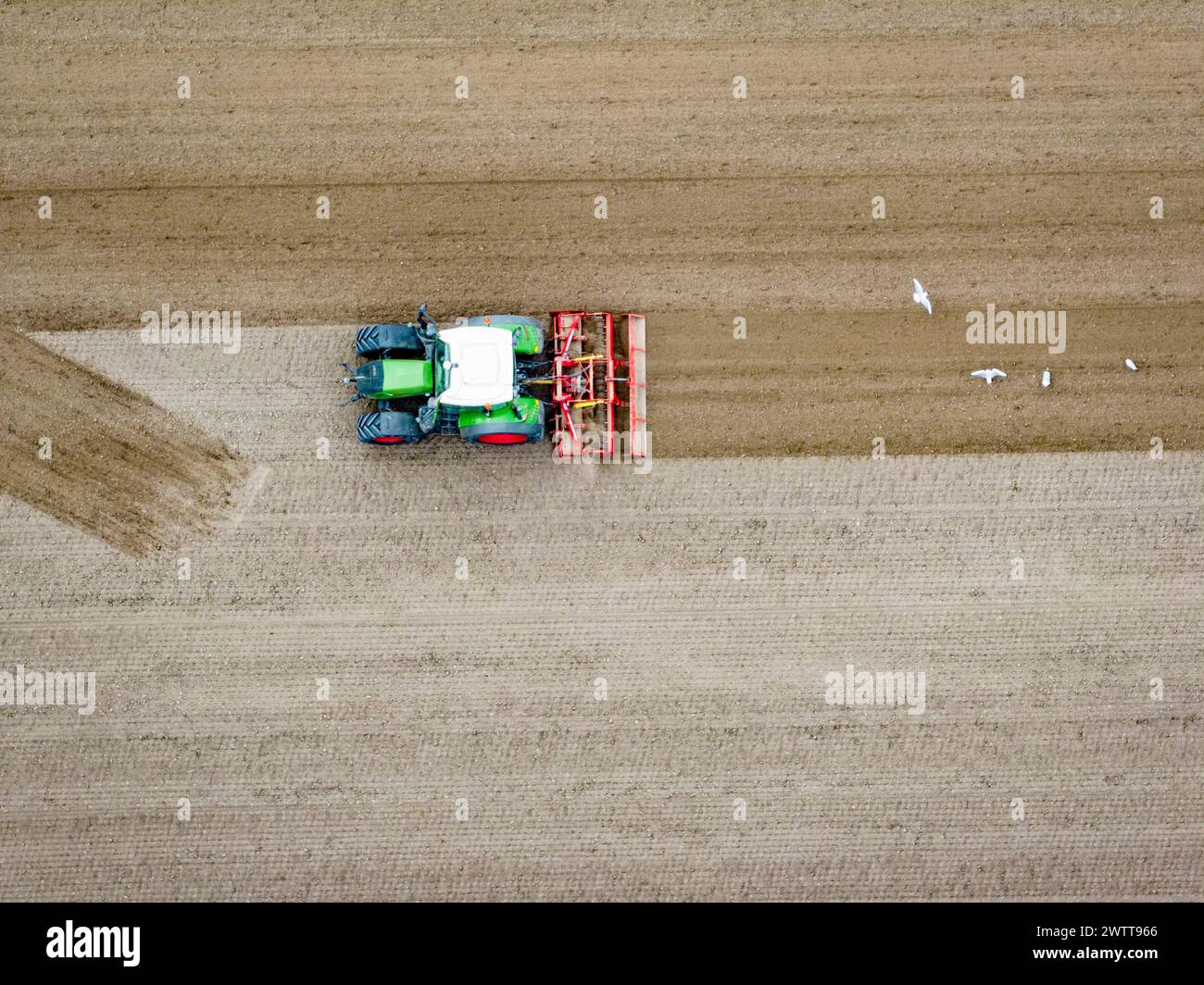 Farmer in his tracker plowing lines in his field ready for harvest ...