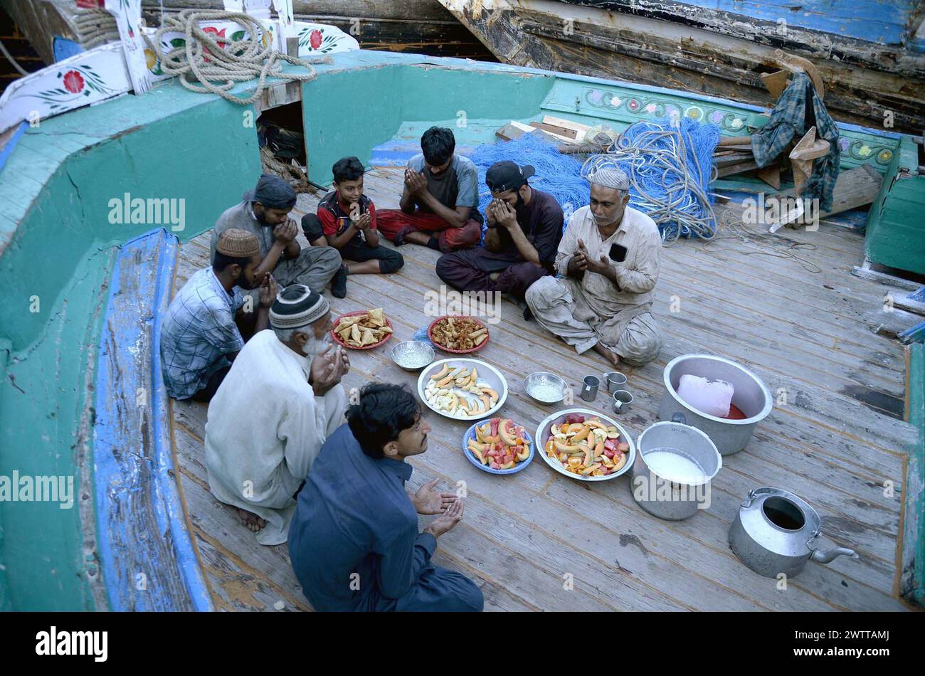 Fishermen are breaking the fast (Iftar) at fishing boat during the Holy ...