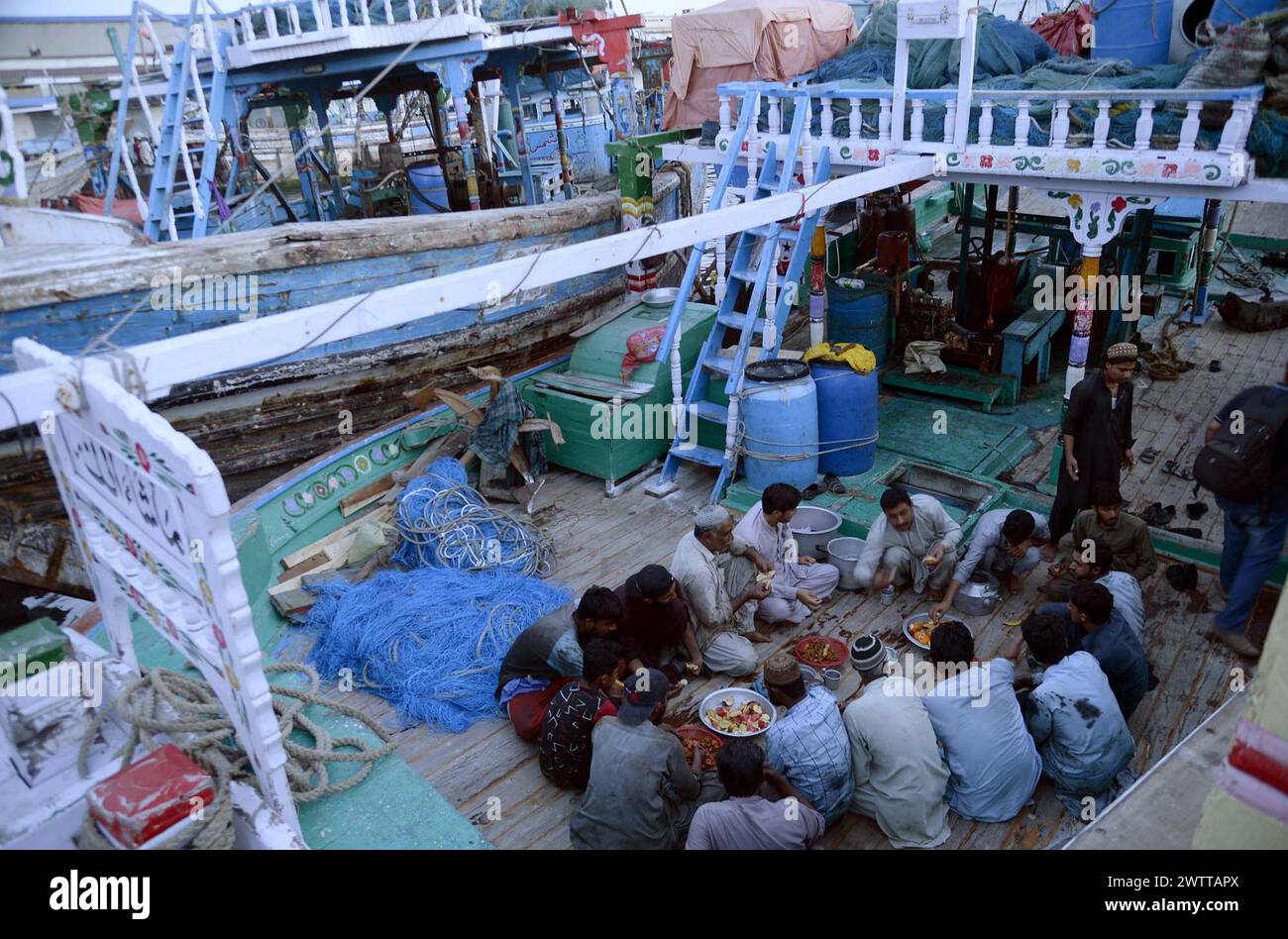 Fishermen are breaking the fast (Iftar) at fishing boat during the Holy ...