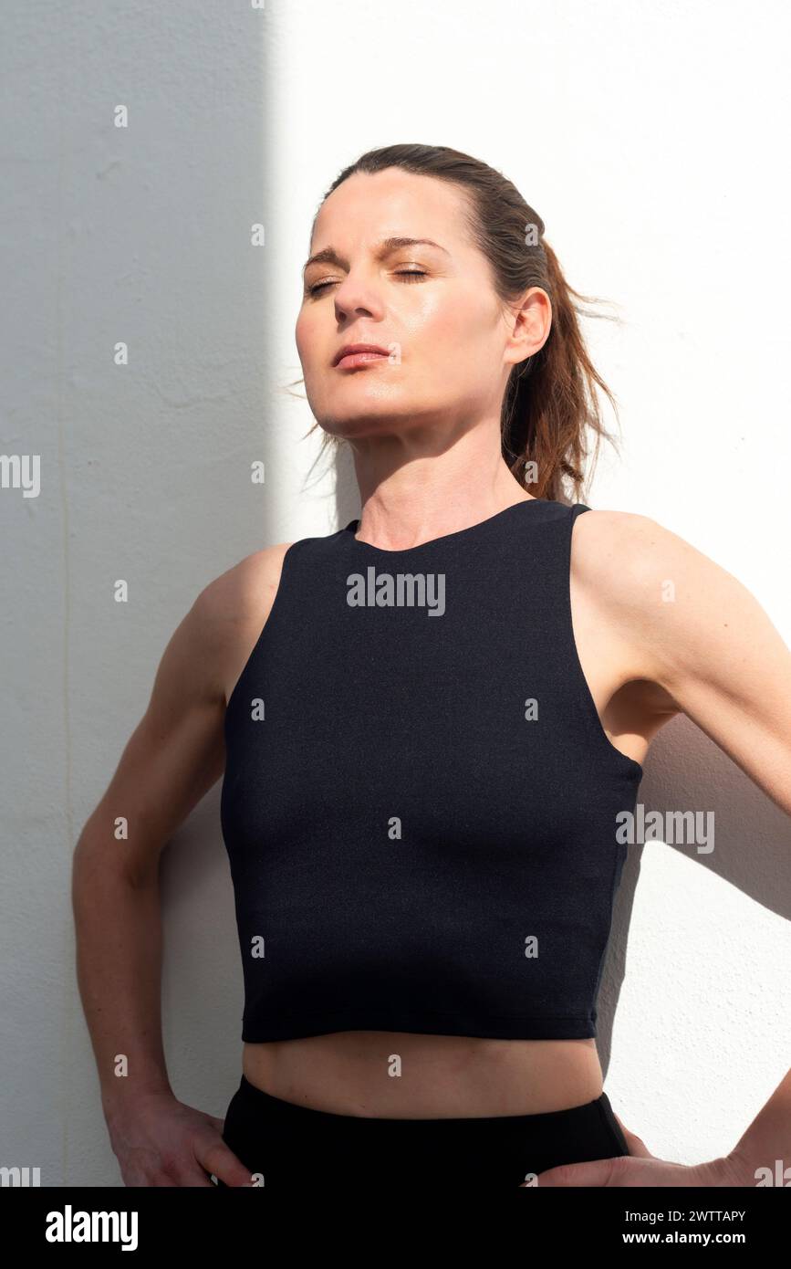 Woman enjoying the sun with eyes closed Stock Photo - Alamy