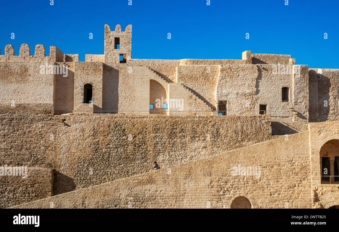 A boy walks down a ramp Inside the southern wall of the Ribat of ...