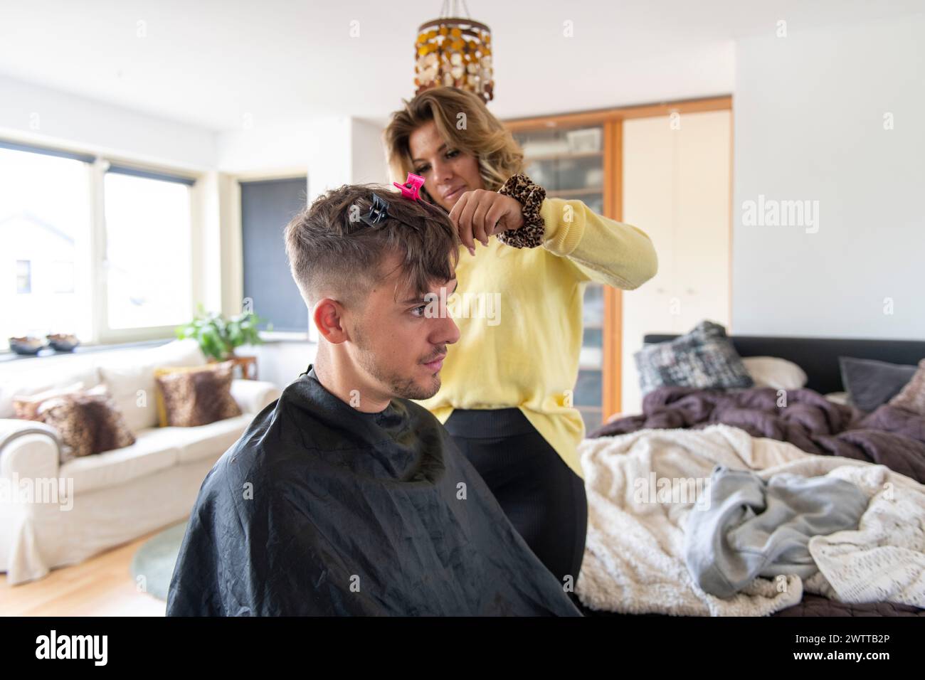 Stylist giving a haircut at home Stock Photo - Alamy