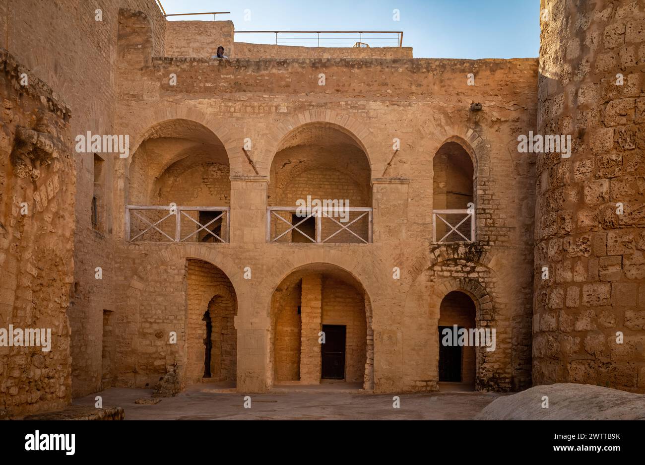 A galleried walkway and arches inside the entrance courtyard at the 8th ...