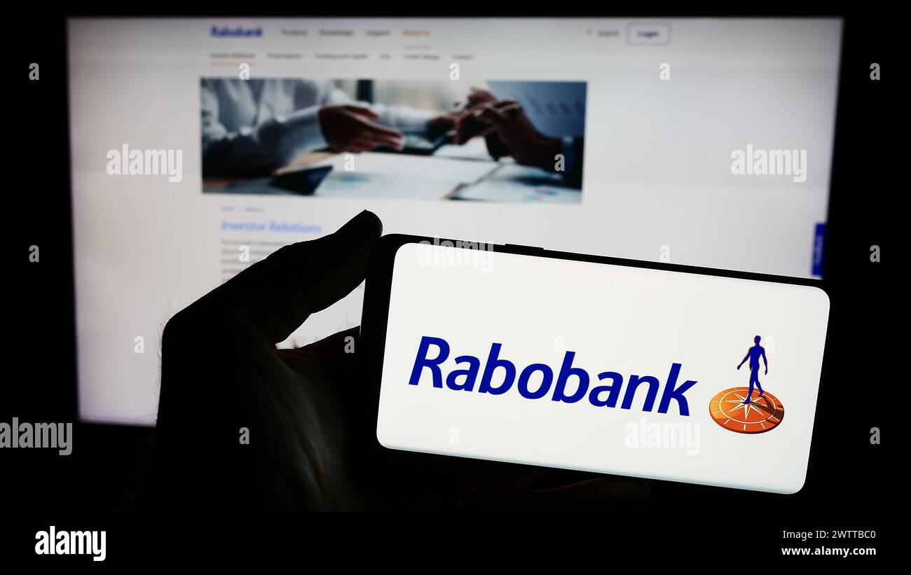 Person holding smartphone with logo of Dutch banking company ...