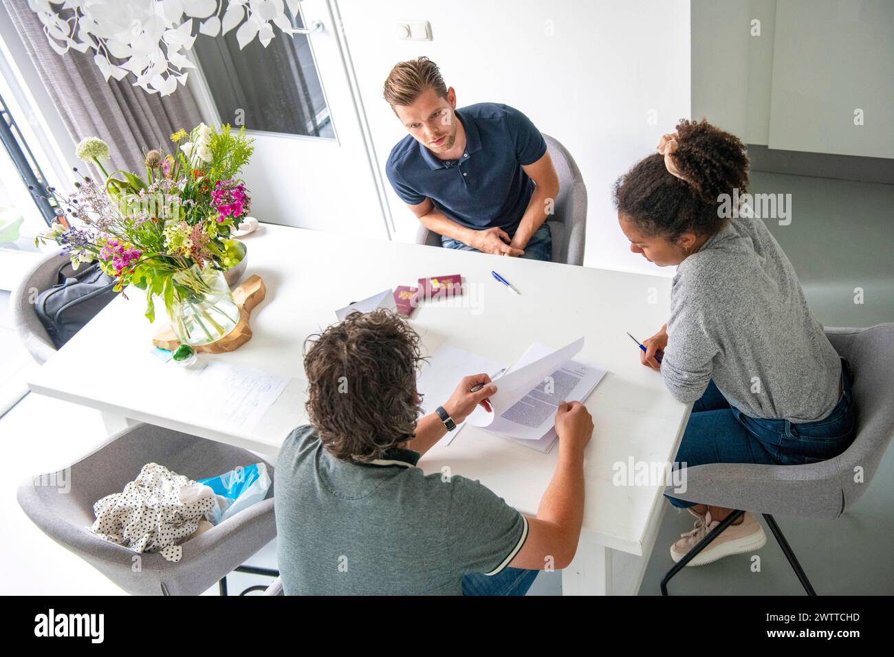 Three people engaged discussibright hi-res stock photography and images ...