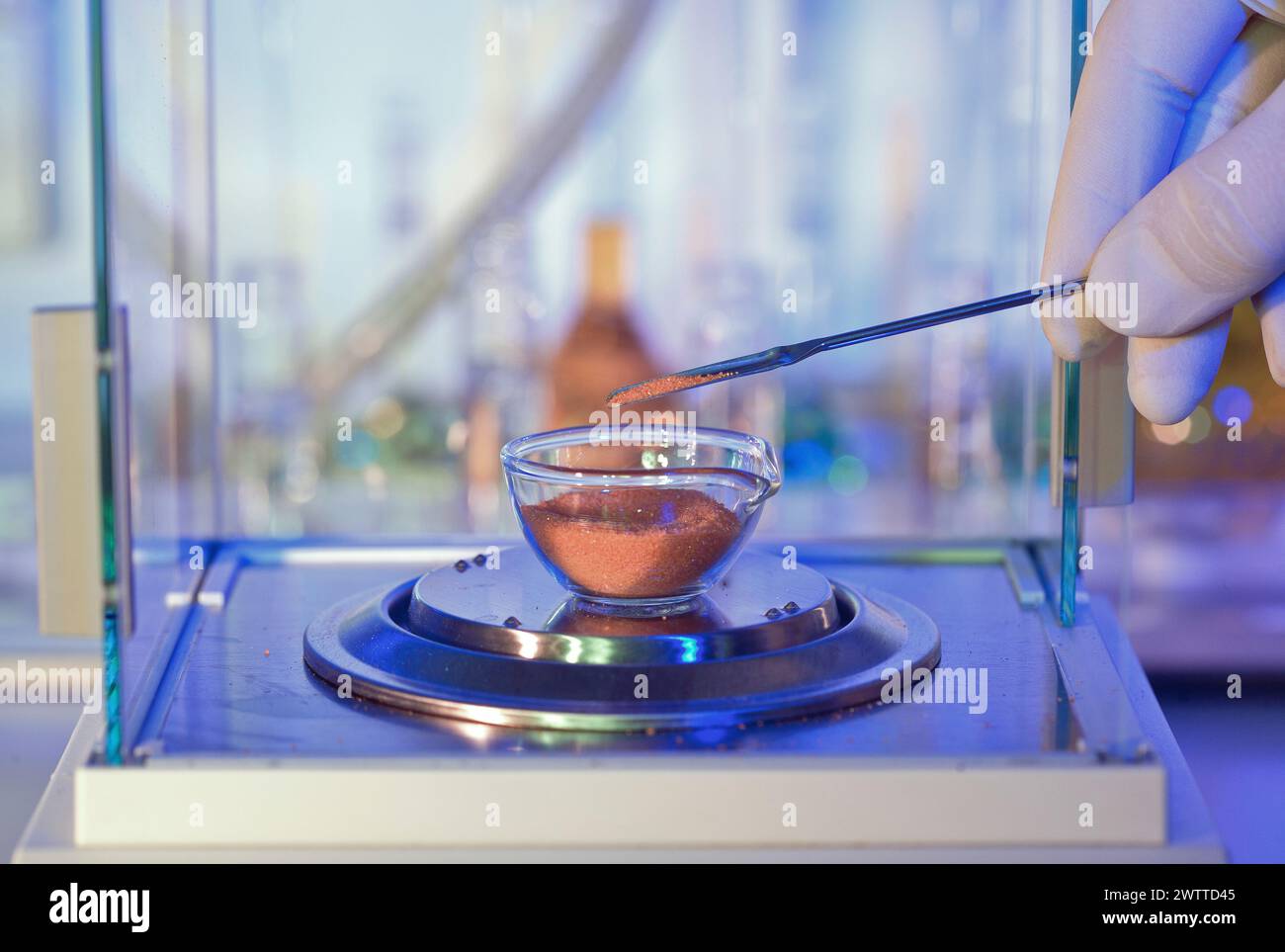 Scientist weighing a sample of fine powder in a laboratory Stock Photo ...