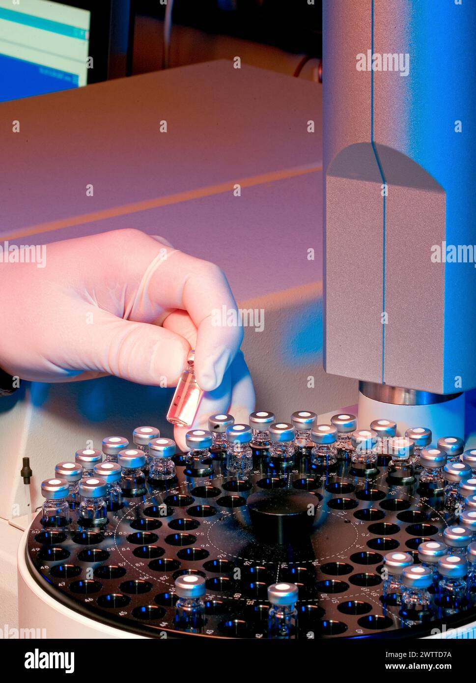 Scientist loading samples into an analytical machine Stock Photo - Alamy