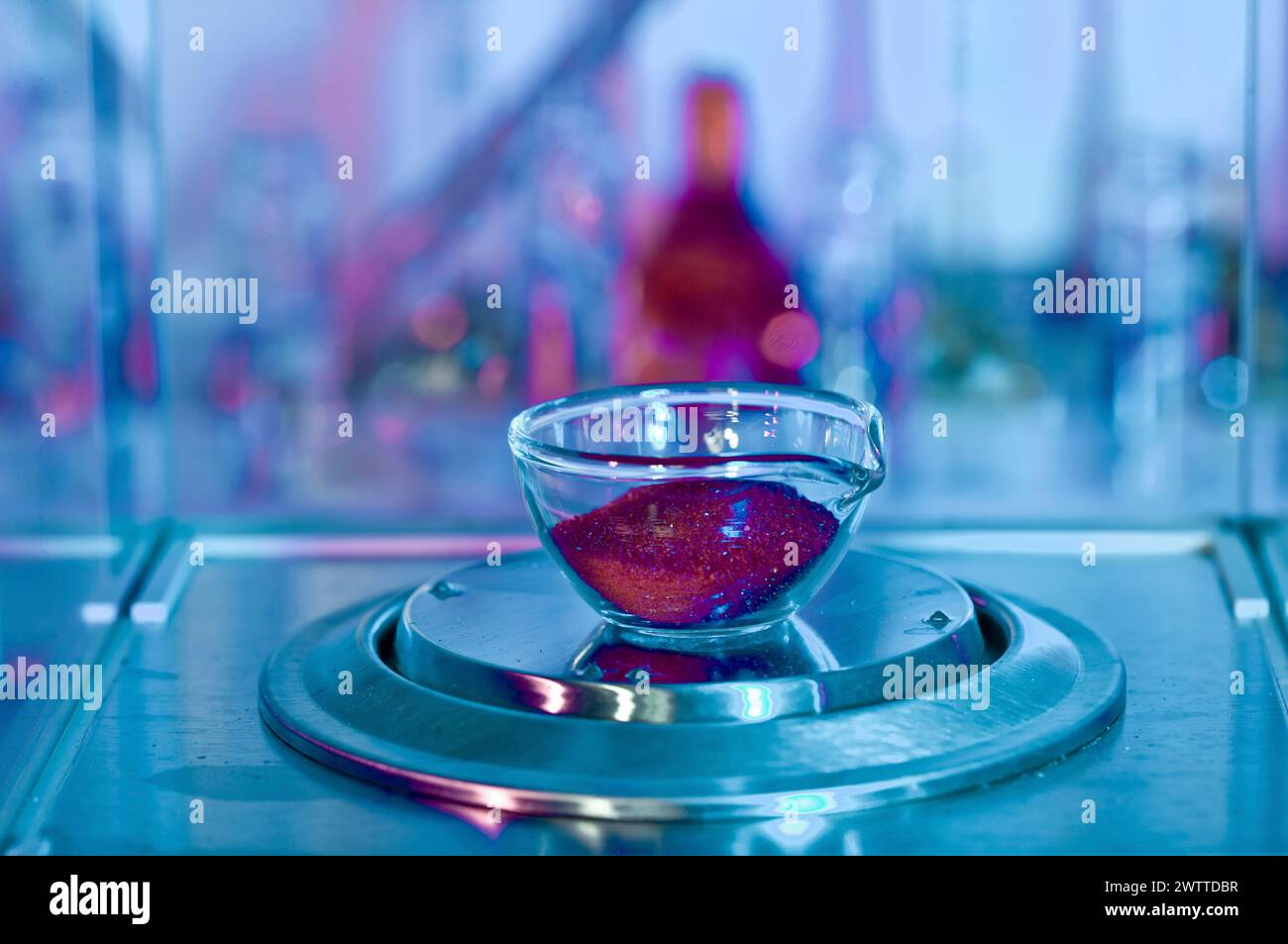 An illuminated laboratory with a vivid blue chemical reaction Stock ...