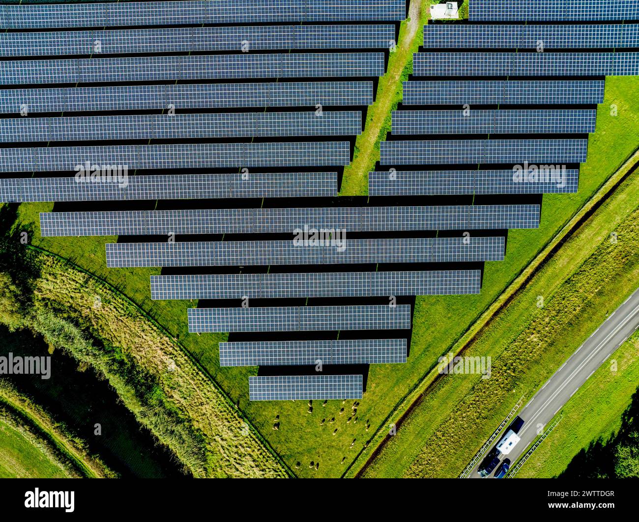 Aerial view of a solar farm flanking a road with cars in motion Stock ...