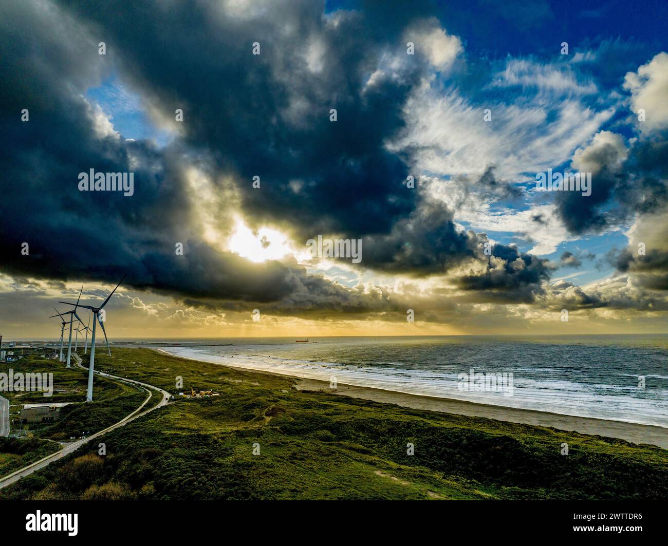 Dramatic skies over a coastal wind farm at sunset Stock Photo - Alamy