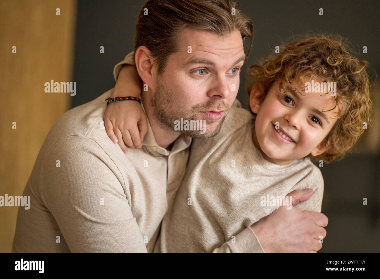 Warm and affectionate moment as a father hugs his young child with a ...