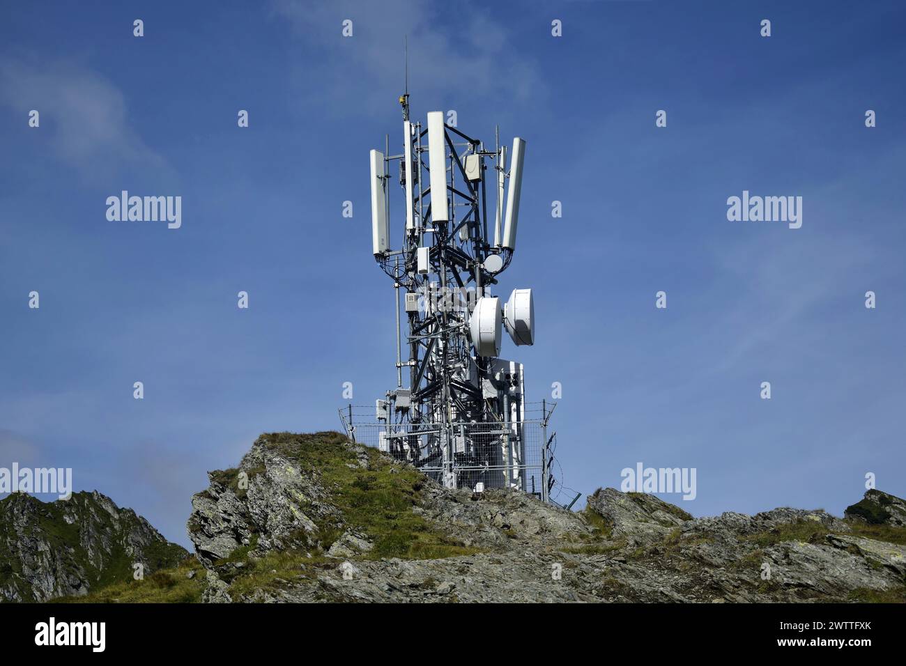 Metal tower with various telecommunication antennas on top of a ...