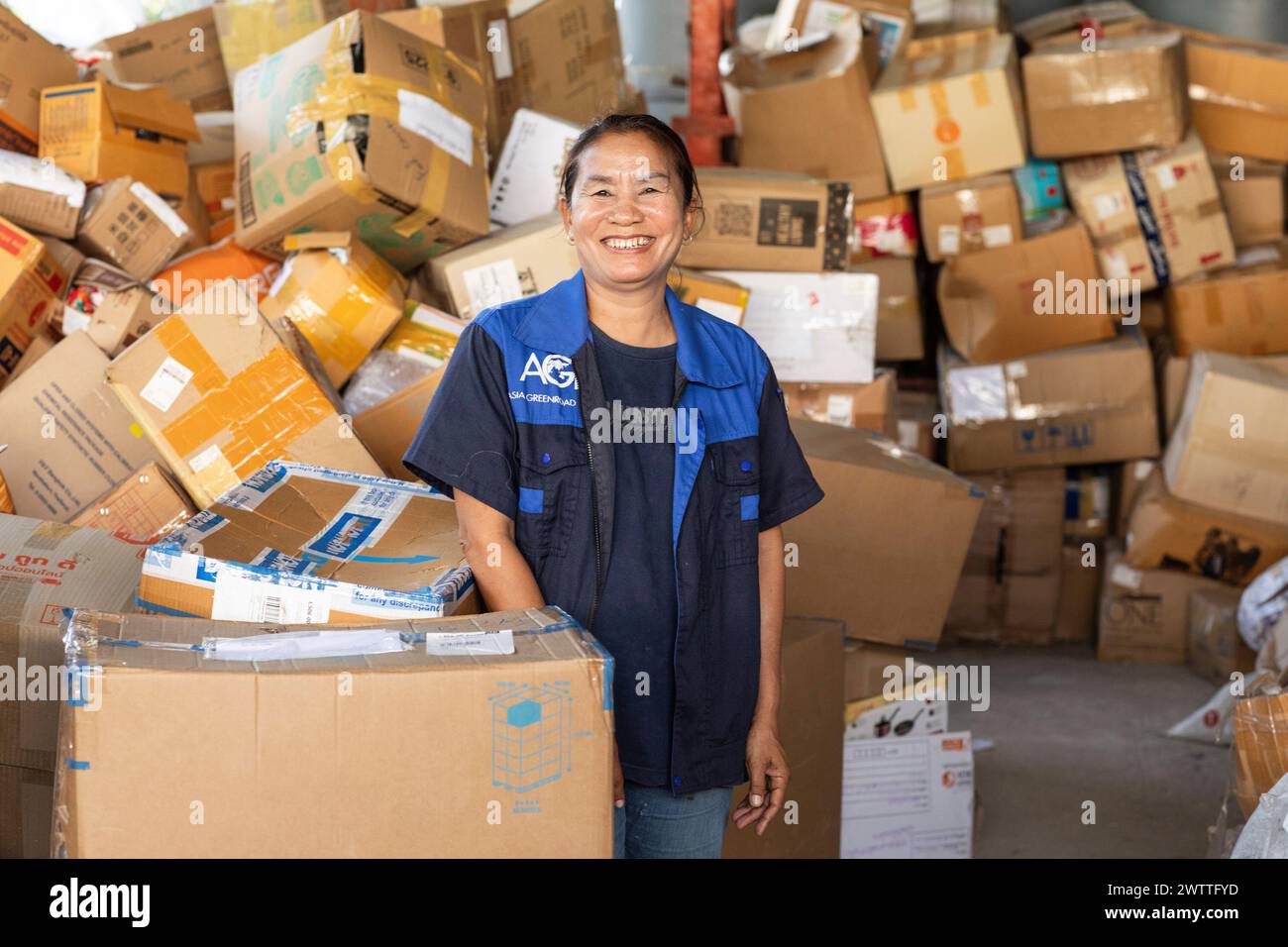 Smiling worker recycling factory surrounded piles parcels hi-res stock ...