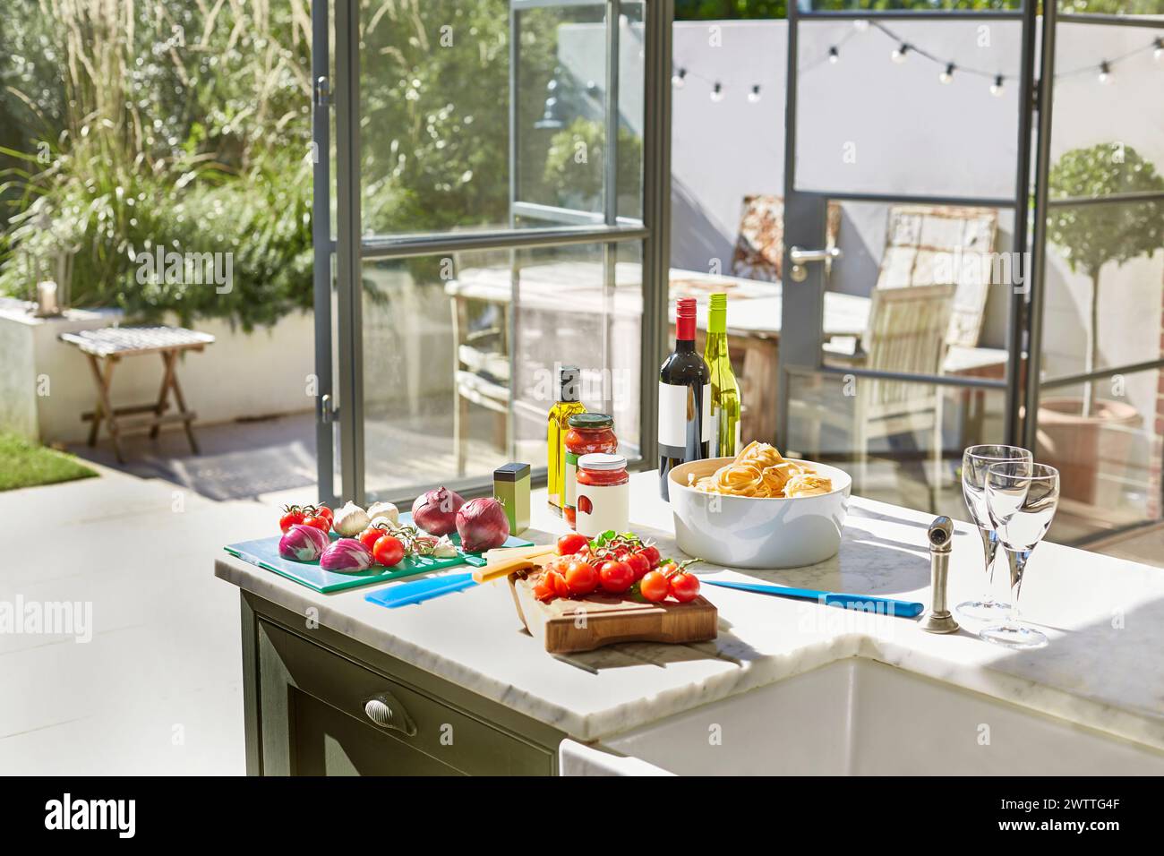 Modern kitchen with food preparation in progress Stock Photo - Alamy