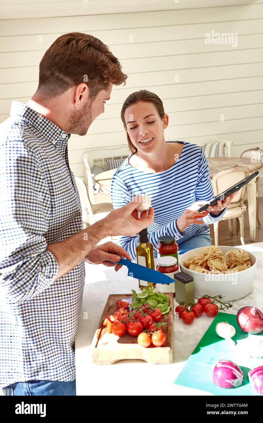 Couple cooking together woman hi-res stock photography and images - Alamy