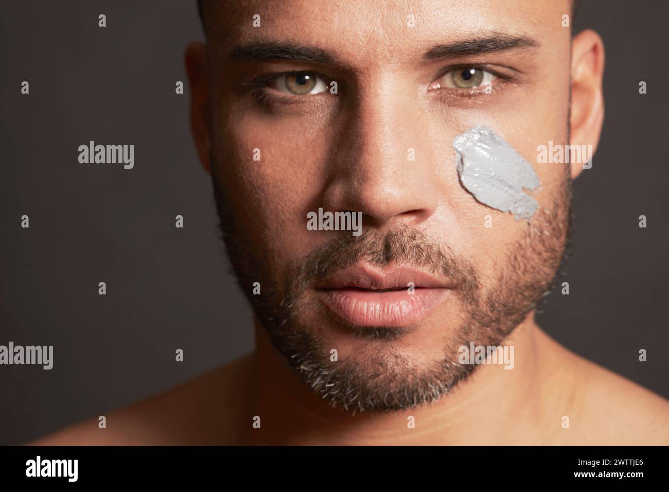Man with facial cream on cheek Stock Photo - Alamy