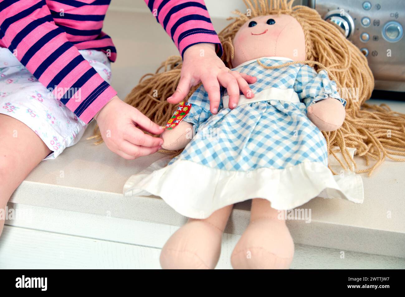 Child playing with doll hi-res stock photography and images - Alamy