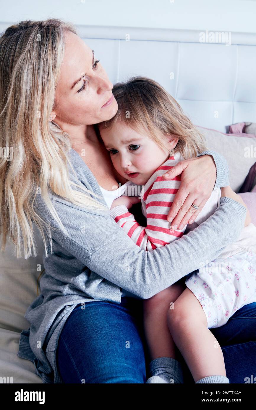 Mother comforting her young child Stock Photo - Alamy